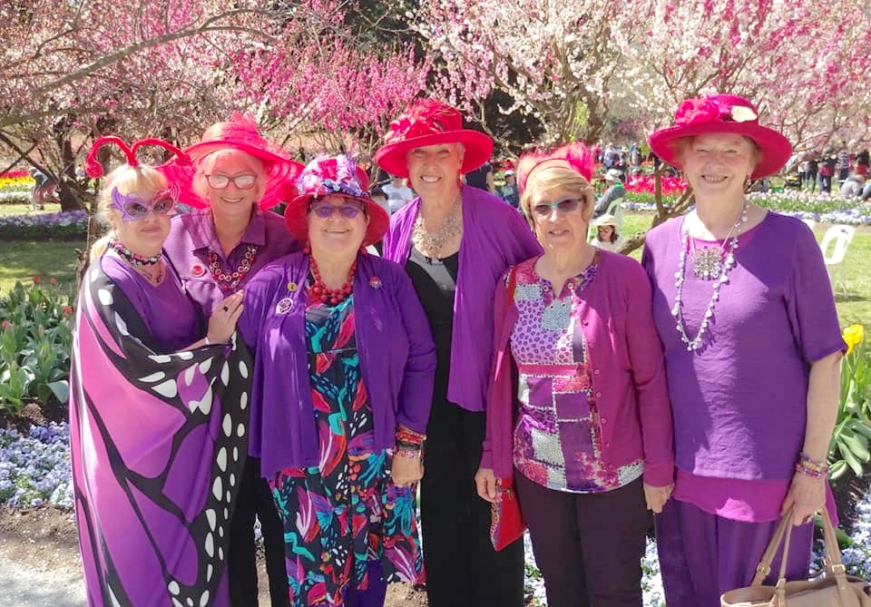 Red Hatters fit in with a splash of purple to connect women in Canberra ...